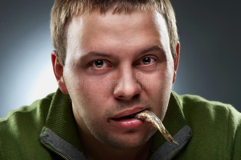 Fun Portrait Of Man With Fish In Mouth Stock Image - Image: 16149971