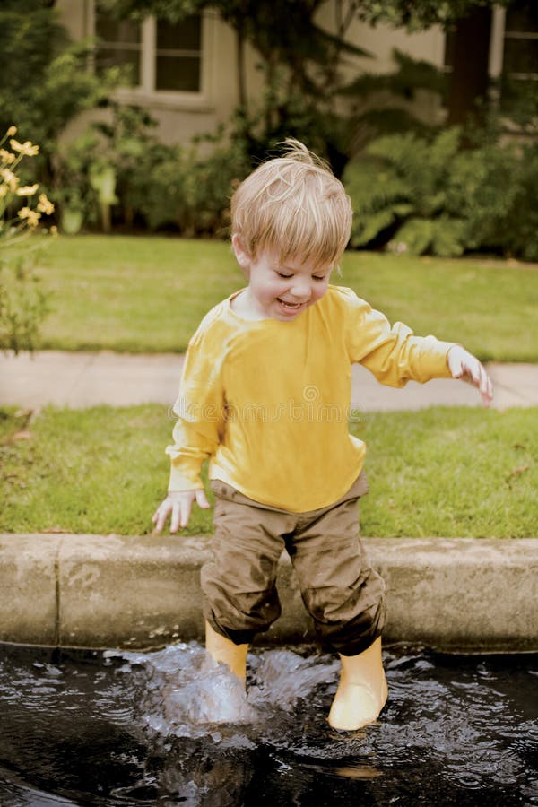 Fun in the puddle stock photo. Image of tree, spring, play - 5490328