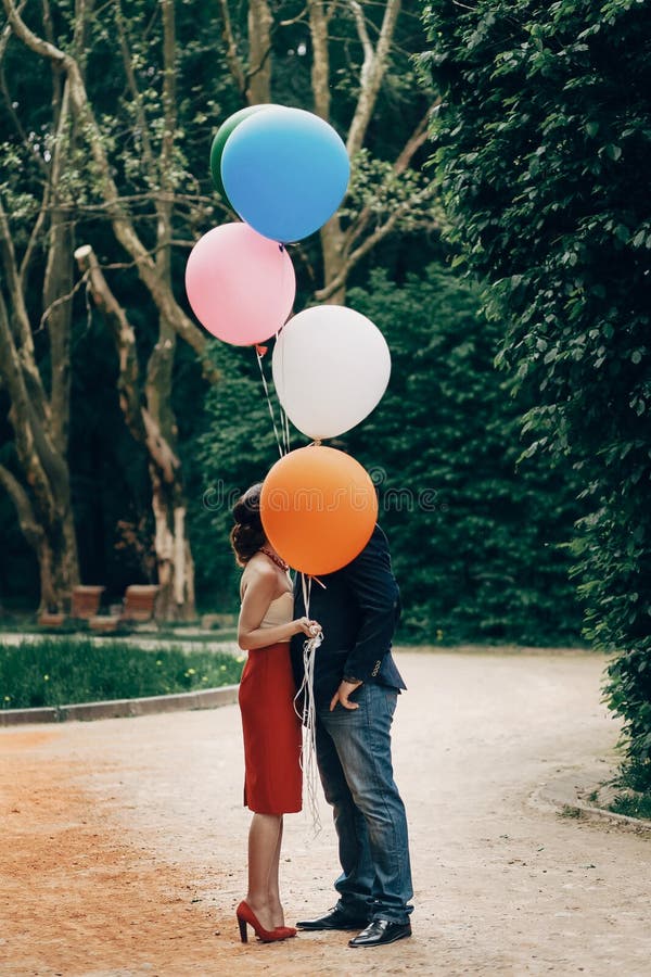 Fun Romantic Couple Kissing Outdoors Beautiful Woman Holding Balloons