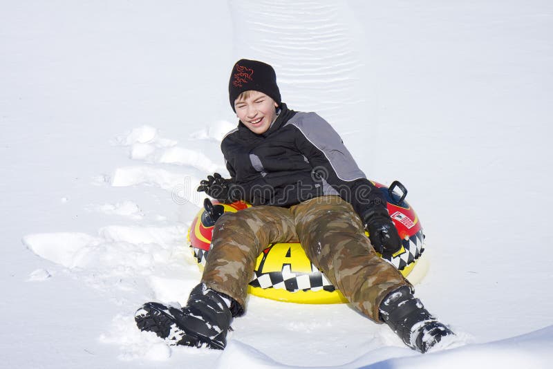 Fun in the Snow stock image. Image of tube, snow, sledding - 12973679