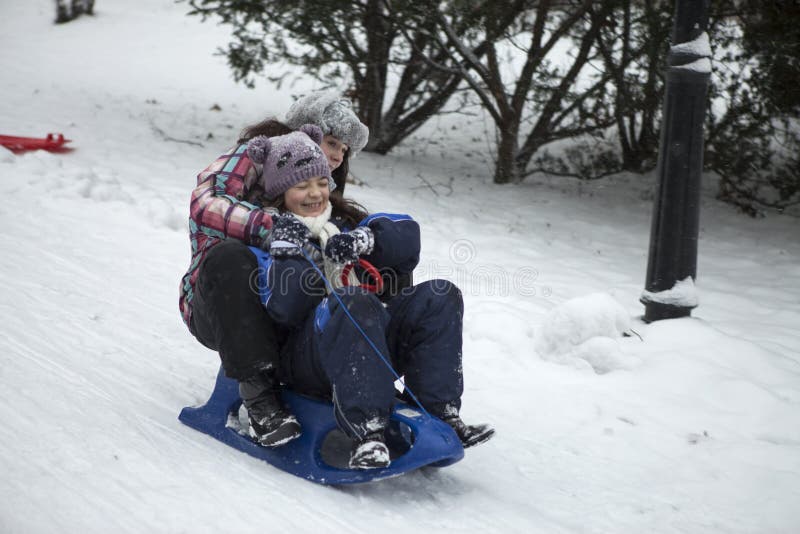 Fun in the snow stock photo. Image of sled, clothing - 28806918