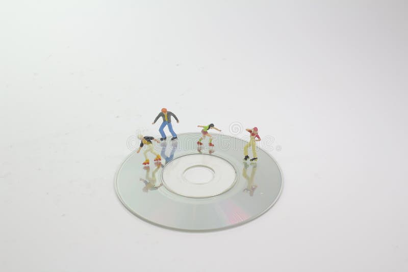 A Fun of Tiny Toy Skaters on CD Stock Image - Image of concept, skating ...