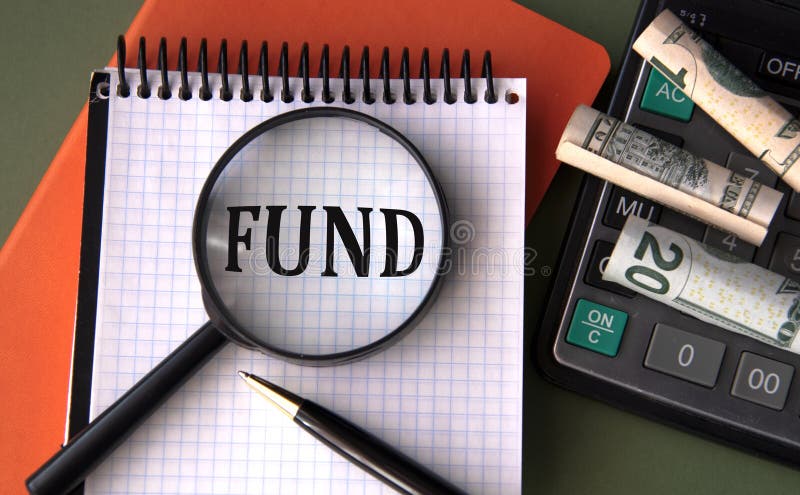 FUND - Word Under Magnifying Glass on the Background of Calculator and ...