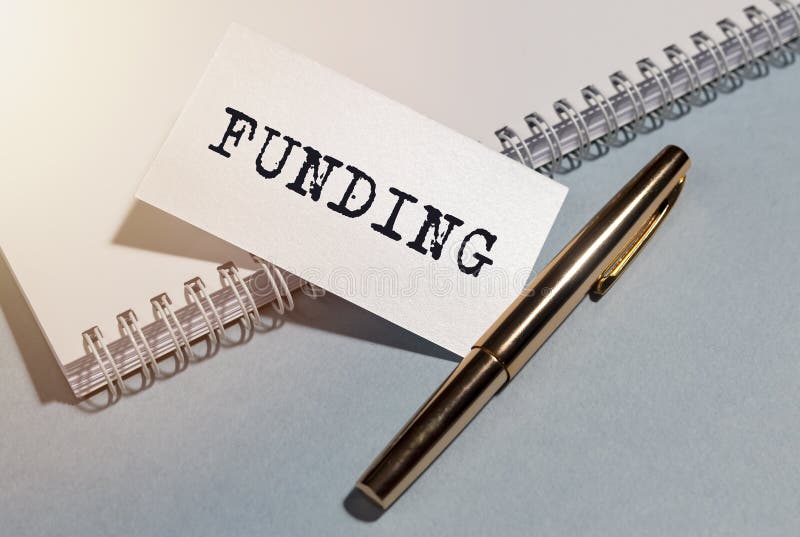 FUNDING Word Written on Paper with Notebook with Pen Stock Image ...
