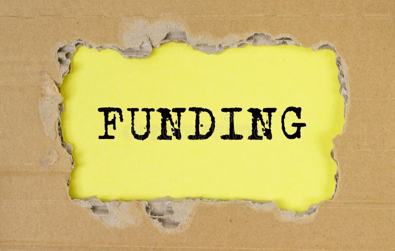 FUNDING Word Written on Yellow Table through Torn Craft Paper Stock ...