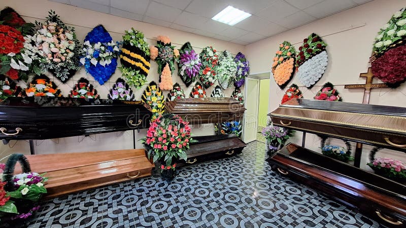 Funeral Home Interior with Coffins and Floral Arrangements Display ...