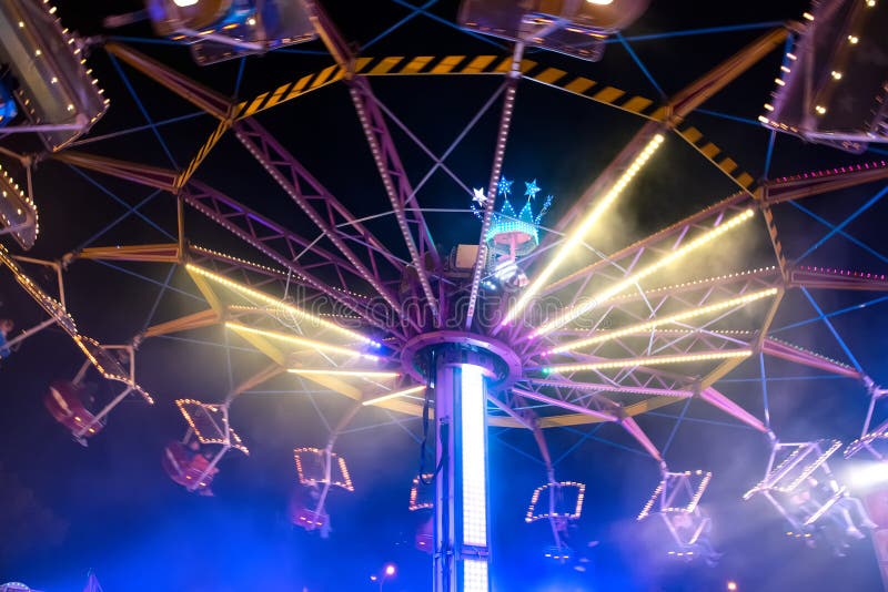 Funfair at Night. a Carousel with Bright Lights of Different Colors at ...