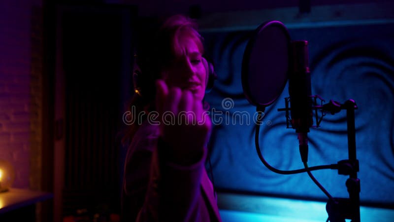 Funky Singer Woman Using Microphone and Headphones, while Recording ... Funky Singer Woman Using Microphone and Headphones, while Recording ...