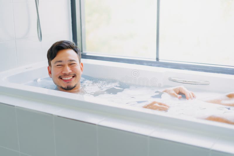 Funny Asian Man Play and Pose in the Bathtub Bathroom. Stock Image ...