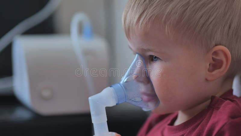 Funny Boy Breathing through an Inhaler Mask. Stock Image - Image of ...