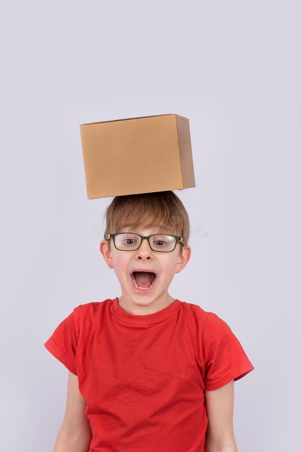 Funny Boy in Glasses Put Box on His Head. Vertical Frame Stock Photo ...