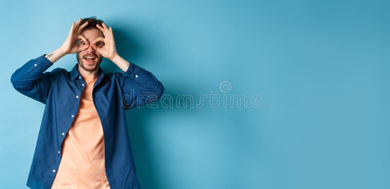 Funny Caucasian Guy Looking through Hand Binoculars and Smiling ...