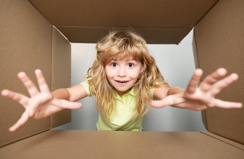 Funny Child Boy is Opening Gift and Looking Inside Cardboard Box. Child ...