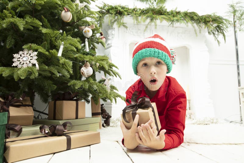 Funny Child at Christmas. Boy in Under the Christmas Tree Stock Image ...