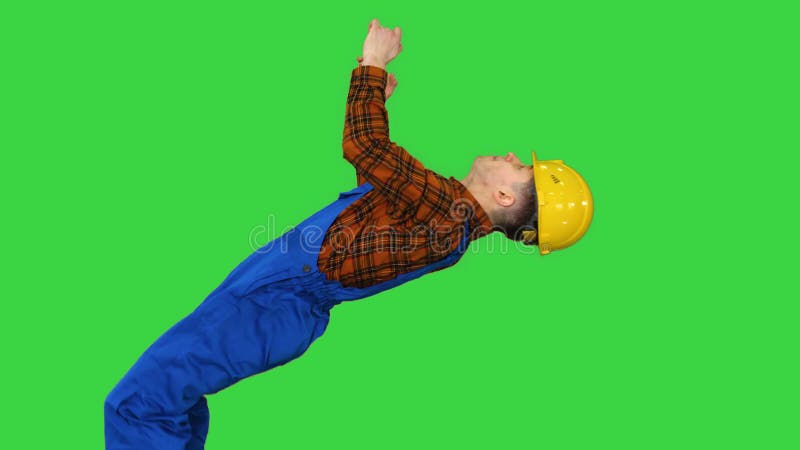 Funny Construction Worker Making a Flip and Loses Safety Hat on a Green ...