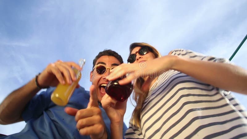 Laughing Drunk Girl with Long Hair is Drinking Wine from Dark Bottle on ...