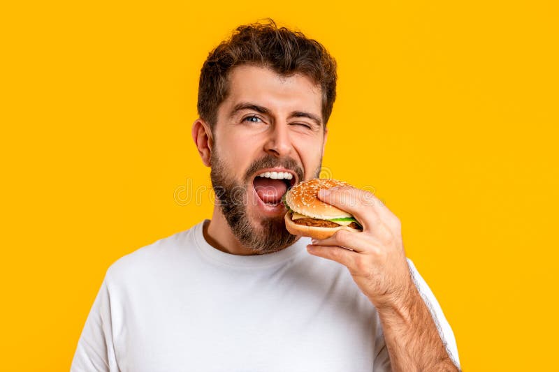Funny Eater Guy Biting Burger Winking Eye at Camera, Studio Stock Image ...