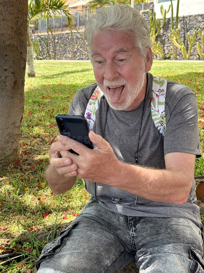 Funny Elderly Man in His Seventies Playfully Sticks Out His Tongue ... Funny Elderly Man in His Seventies Playfully Sticks Out His Tongue ...