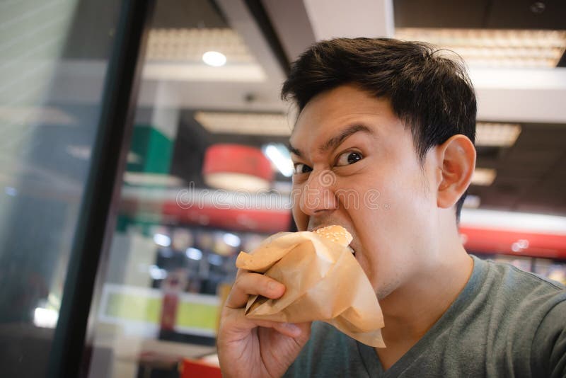 Funny Face Expression of Asian Man Eat a Hamburger Stock Image - Image ...