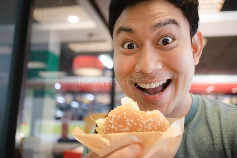 Funny Face Expression of Asian Man Eat a Hamburger Stock Photo - Image ...