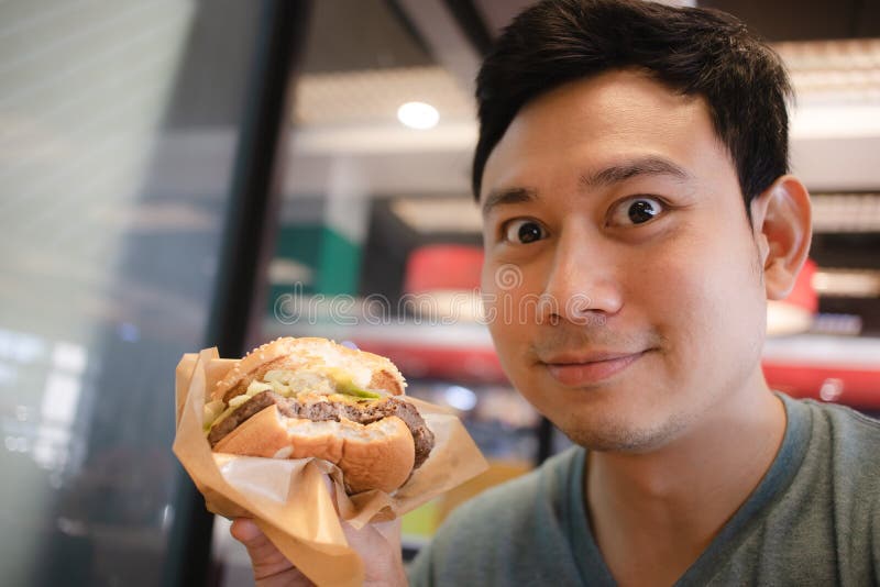 Funny Face Expression of Asian Man Eat a Hamburger Stock Image - Image ...