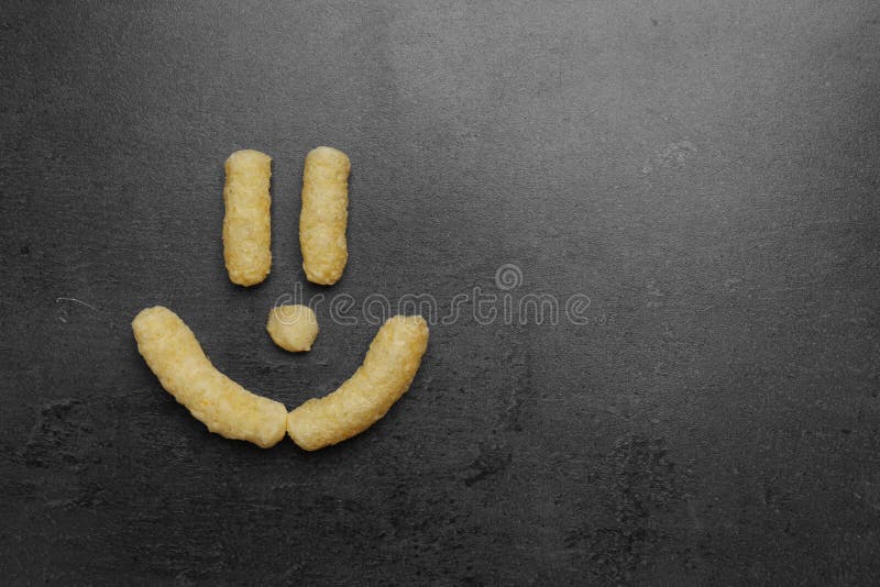 Funny Face Made of Corn Sticks on Dark Grey Table, Flat Lay. Space for ...