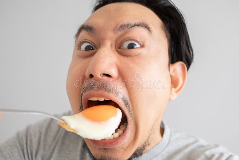 Funny Face of Man Eats Fried Egg for Protein. Stock Image - Image of ...