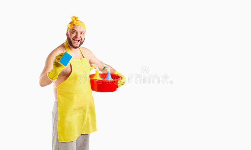 Funny Fat Man in an Apron and Yellow Cleaning Gloves is Cleaning in the ...