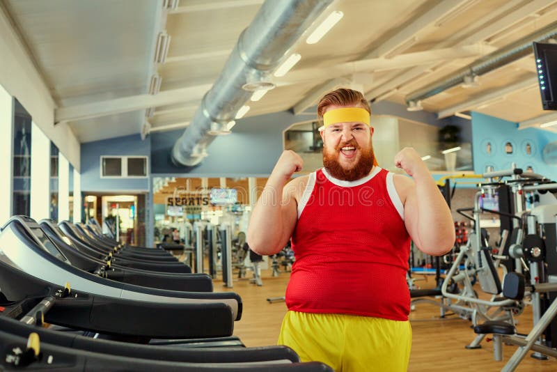 A Funny Fat Man Doing Exercises in the Gym. Stock Photo - Image of ...