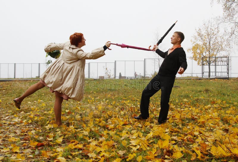 Funny Fencing with Umbrellas Stock Photo - Image of holding, joke: 12038526