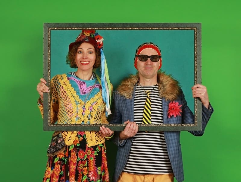 Funny Freaky Couple Posing in the Studio Holding a Picture Frame in ...