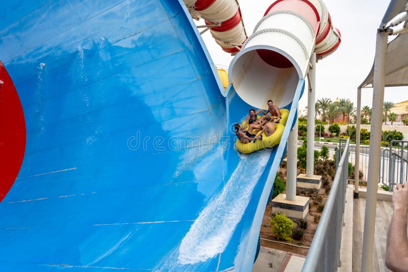 Friends Having Fun and Rolling on Big Water Slide Stock Photo - Image ...