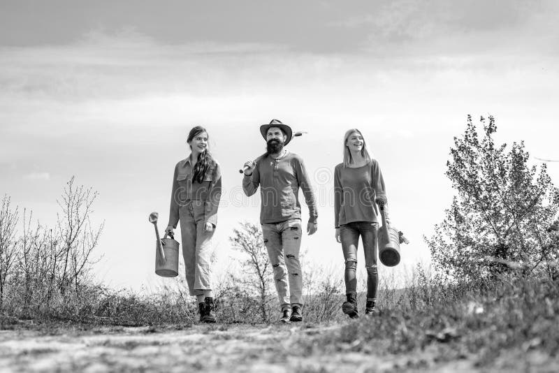 Funny Friends Walking in Spring Garden. Friends Working in Garden ...