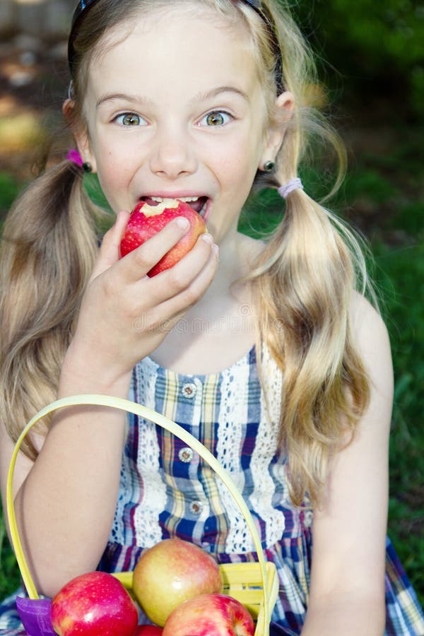 Funny girl eating apple stock image. Image of fruit, sweet - 21983485