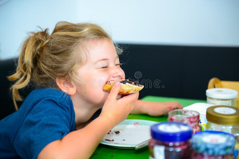 Funny Girl Eating Bread Roll with Marmelade Stock Photo - Image of ...