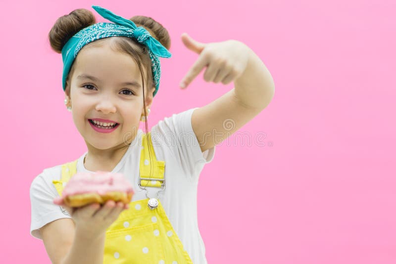 Funny Girl Smiling and Pointing at a Donut. Stock Photo - Image of ...