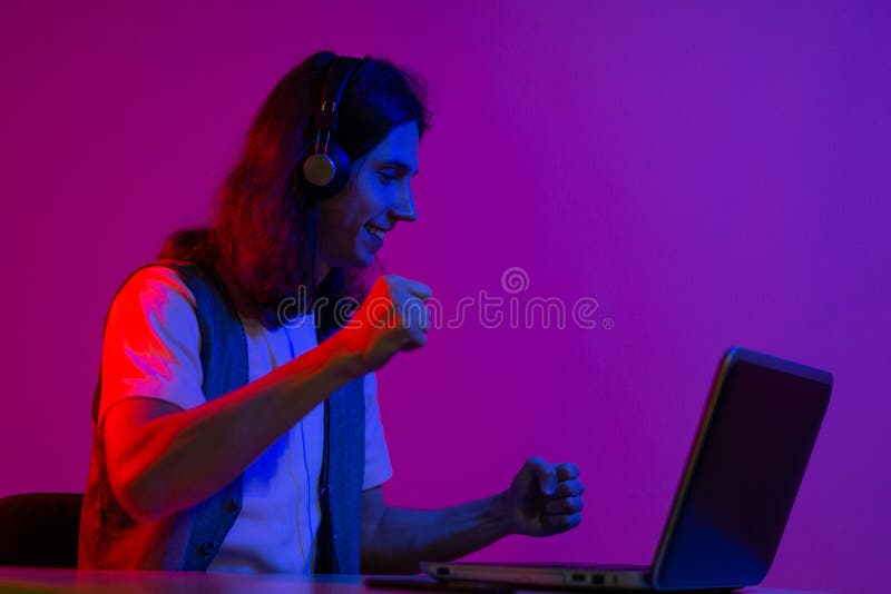 Funny Guy Gamer Playing on a Laptop. a Young Man with Headphones Stock ...