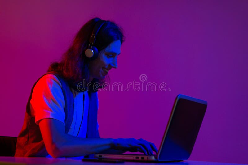 Funny Guy Gamer Playing on a Laptop. a Young Man with Headphones Stock ...