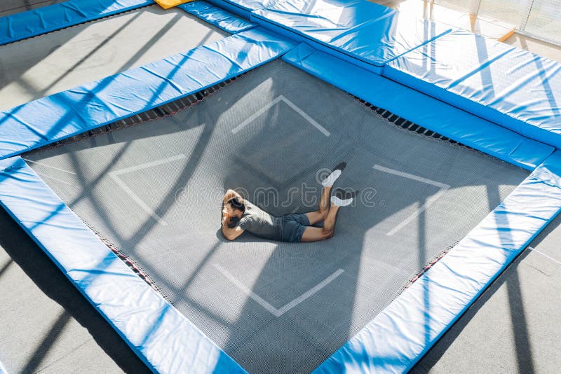 Funny Guy Lying on the Trampoline and Having a Rest after Intensive ...