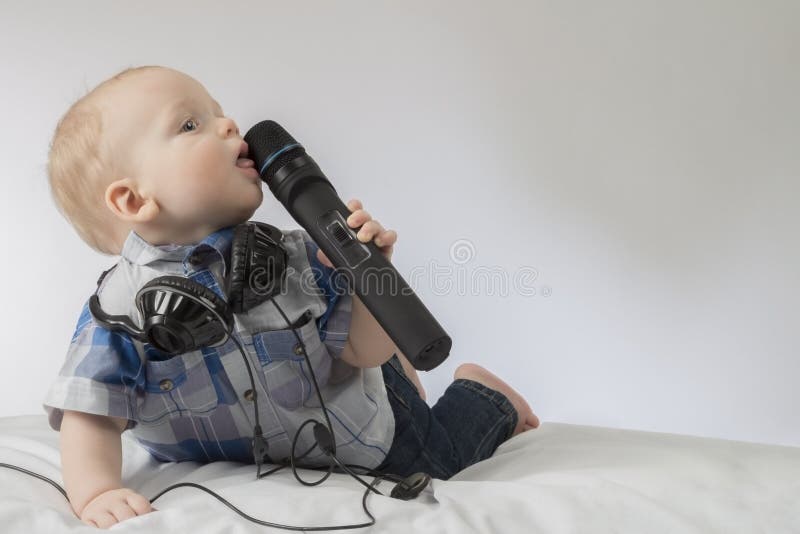 Funny Infant Boy Licking Microphone. Horizontal Studio Shot Stock Photo ...