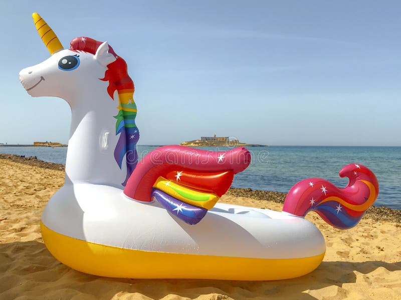Funny Inflatable Unicorn Ring on Sandy Beach Near Sea. Stock Image ...