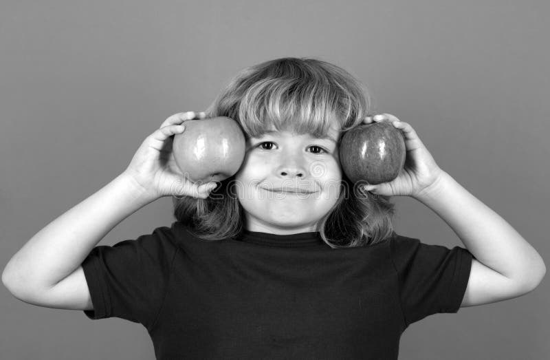 Funny Kid Boy Hold a Red Apple and a Green Apple. Isolated on Studio ...