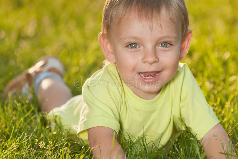 Funny Little Boy Lying on the Green Grass Stock Photo - Image of ...