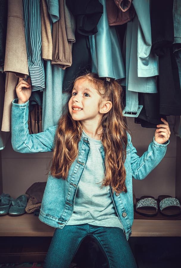 Funny Little Girl Having Fun in the Wardrobe with Clothes. Stock Image ...