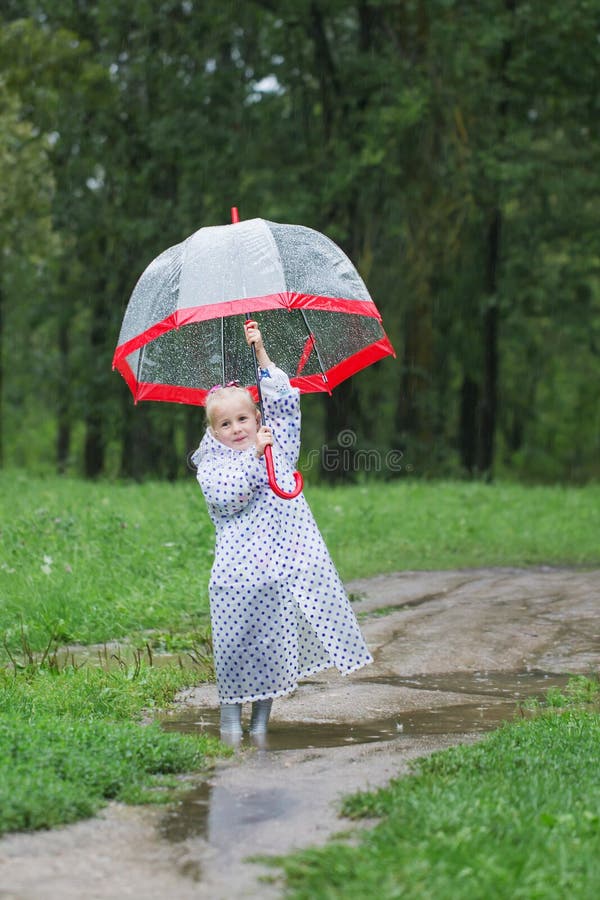 Funny Little Girl with Umbrella in Rain Stock Photo - Image of ...