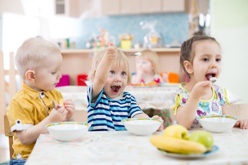 Funny Little Kid Playing and Eating in Kindergarten Stock Photo - Image ...