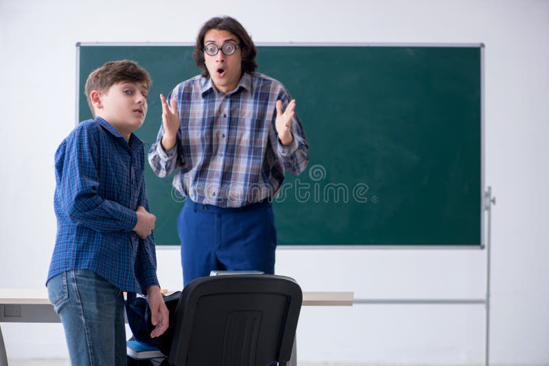 Funny Male Teacher and Boy in the Classroom Stock Photo - Image of ...