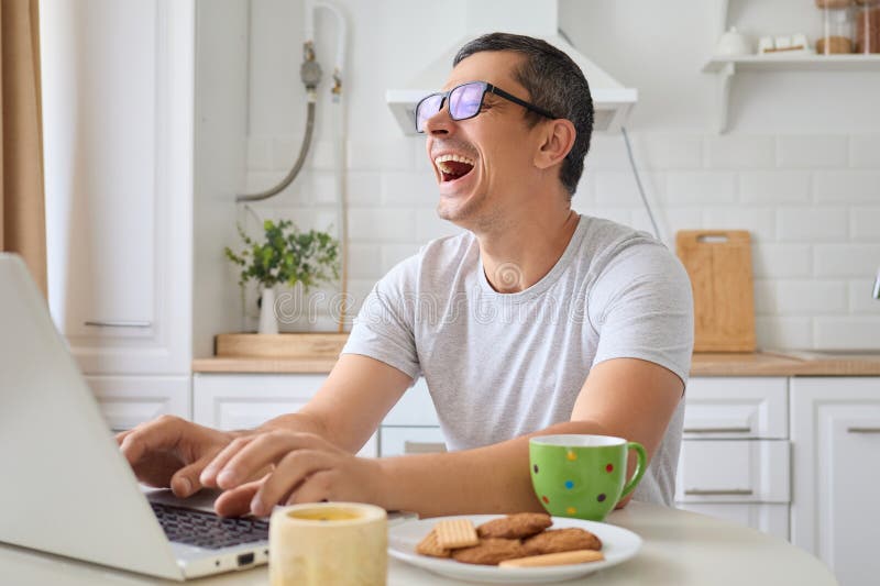 Funny Man Freelancer Working on Laptop while Sitting at Table Laughing ...