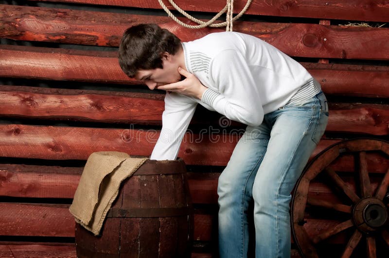 A Funny Man is Looking at Something in a Barrel. Stock Image - Image of ...