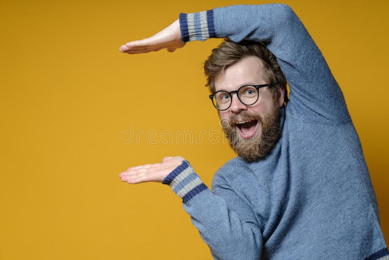 Funny Man Shows Using Some Size, Standing in an Unusual Pose and Smiles ...